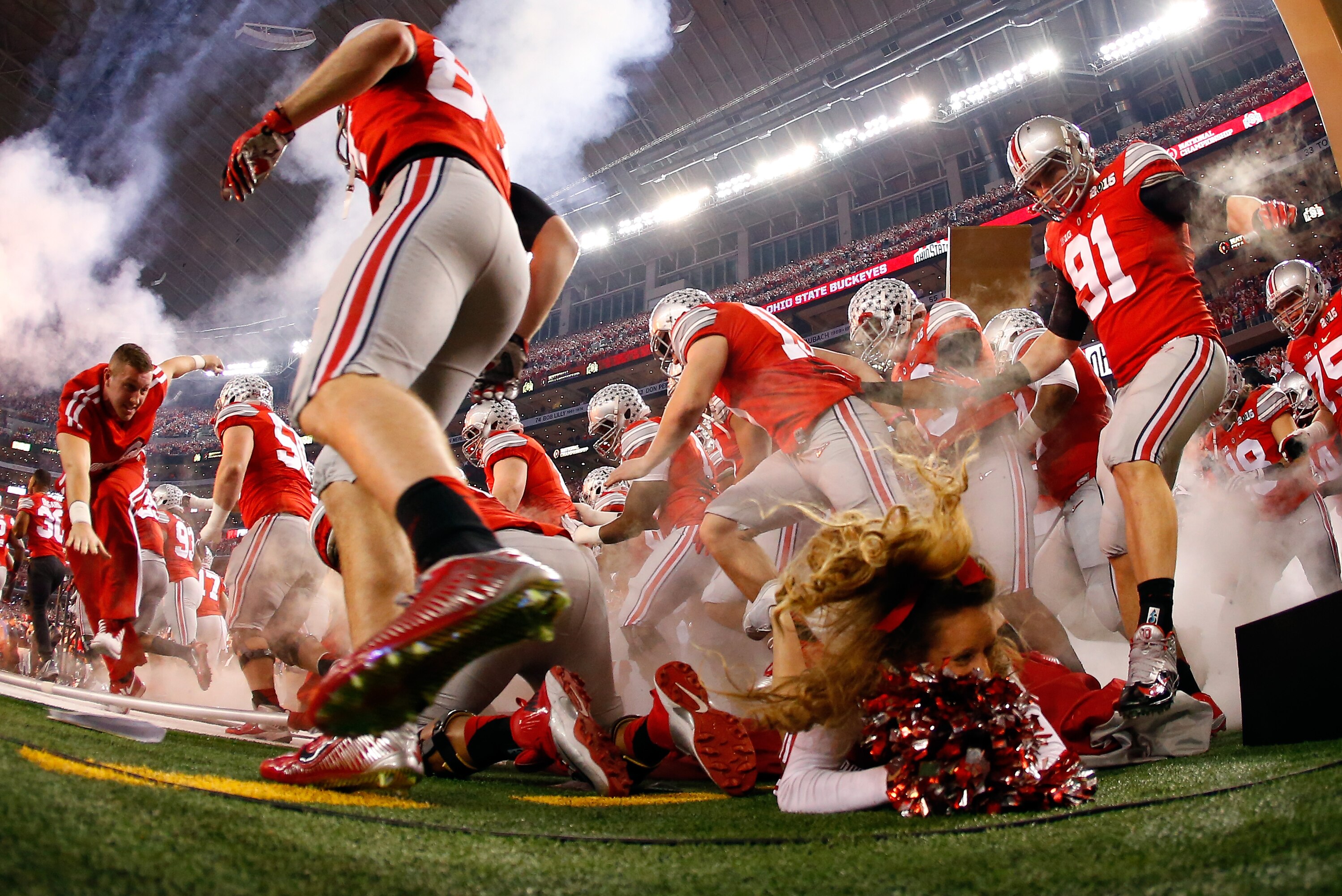 Ohio State Cheerleader Nearly Trampled as Players Run onto Field